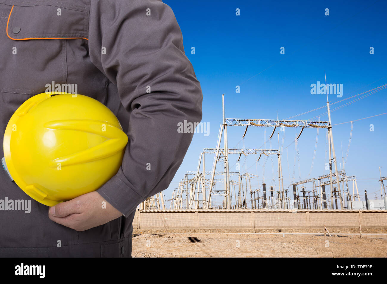 man technician with power transmission station Stock Photo - Alamy
