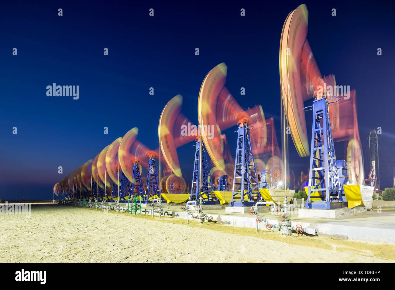 working oil-rig of oilfield day and night Stock Photo - Alamy