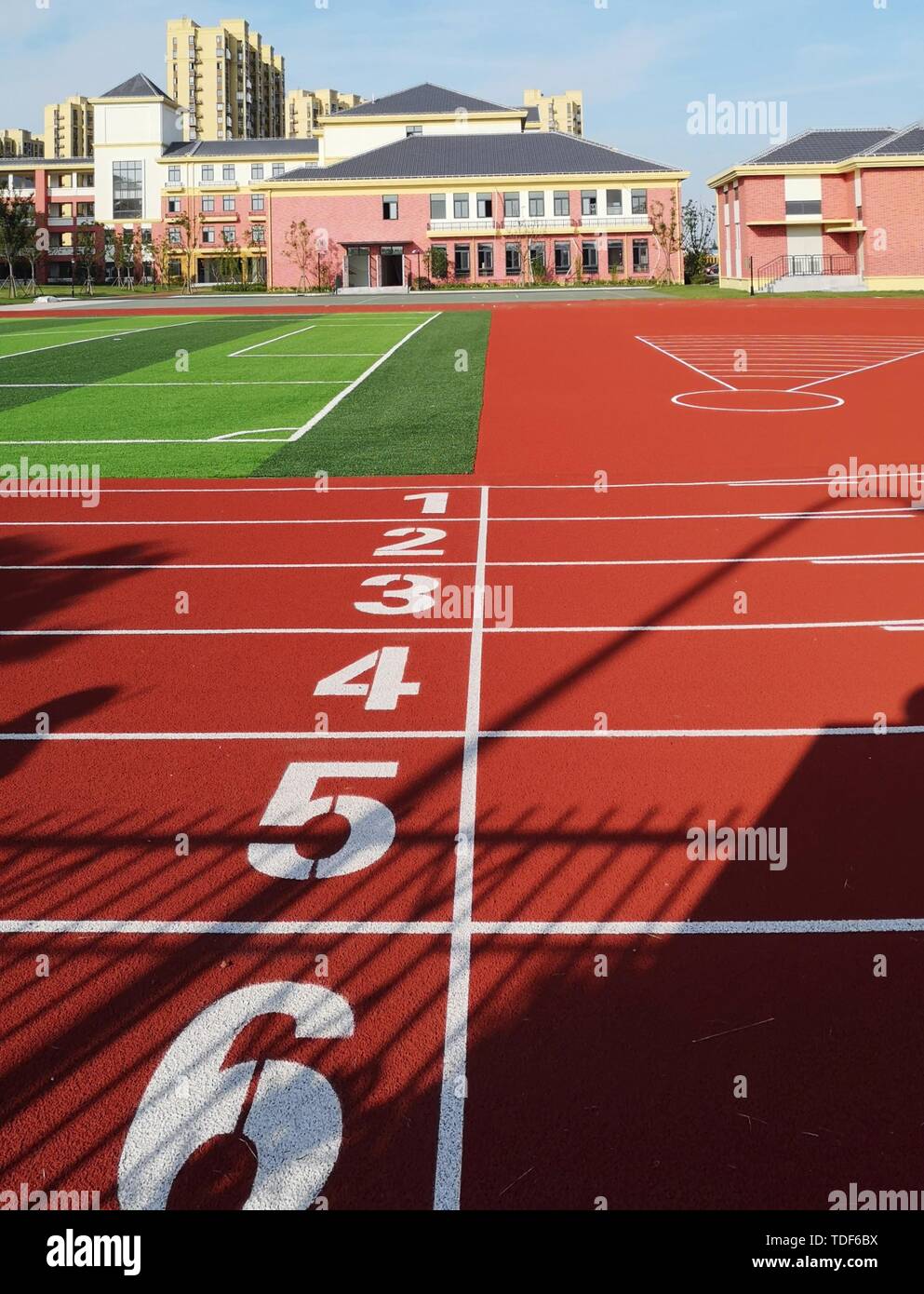 Middle school playground track and field track Stock Photo - Alamy