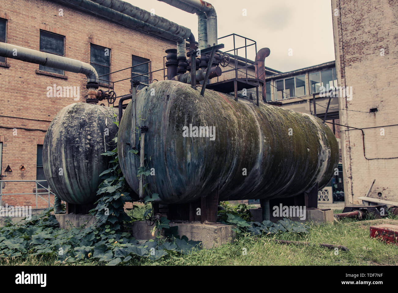 Rust-stained steel oil tanks in unabandoned factories Stock Photo - Alamy