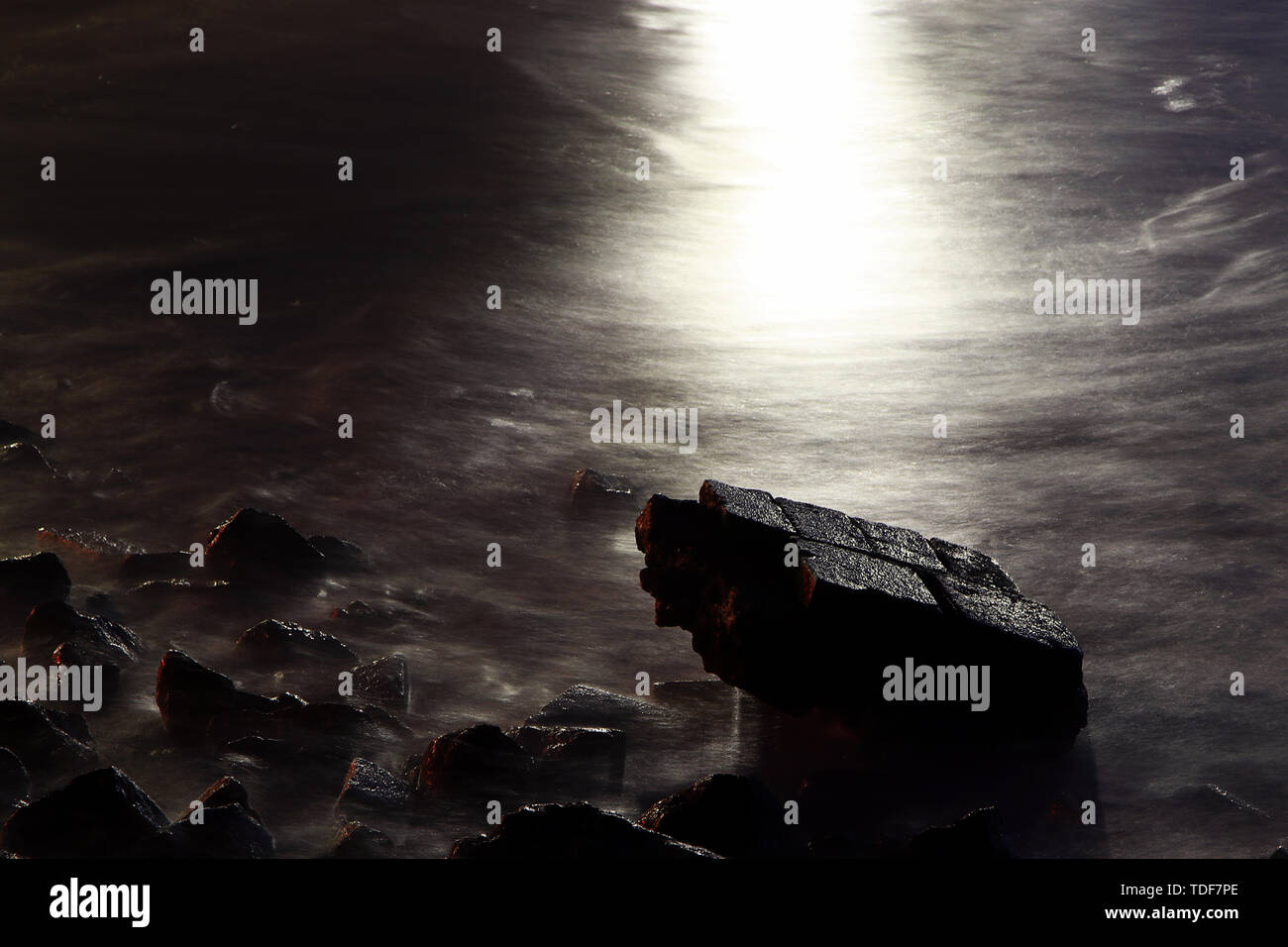 A beam of light illuminated on the rocks Stock Photo - Alamy