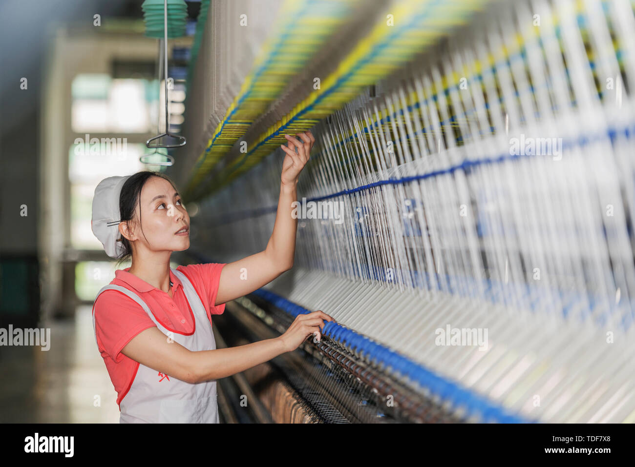A woman in a textile factory Stock Photo - Alamy