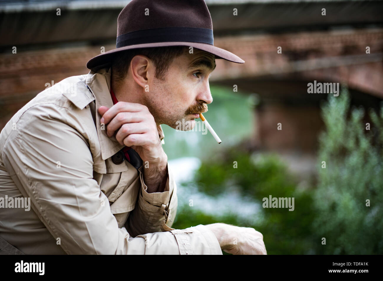 Vintage detective smoking a sigarette ina city slum Stock Photo - Alamy