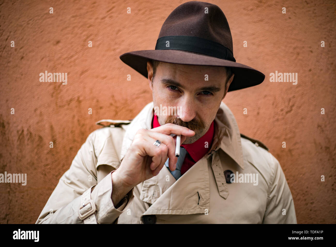 Vintage detective smoking a sigarette ina city slum Stock Photo - Alamy