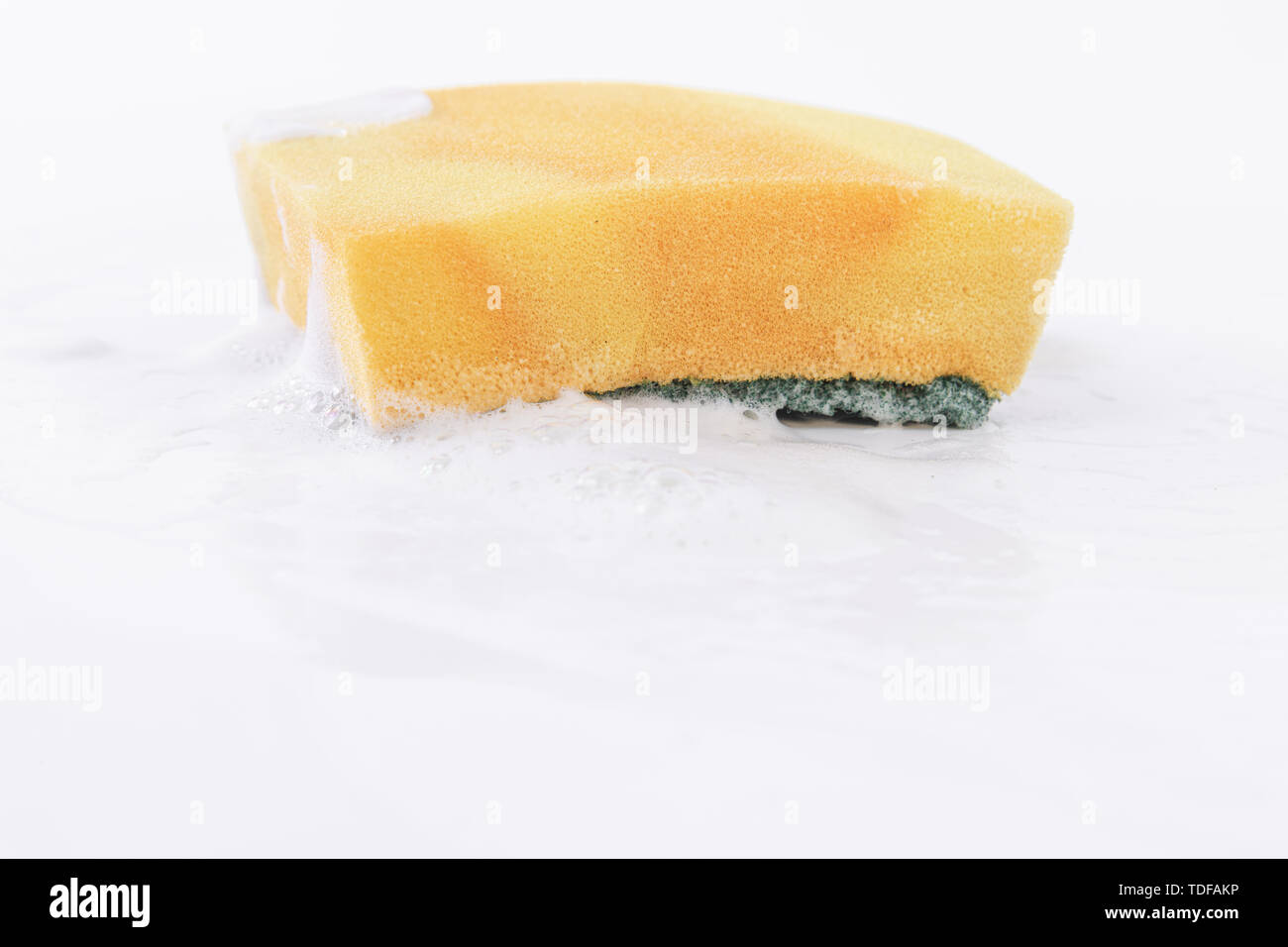 Dishwasher sponge with many bubble of liquid isolated on white ...