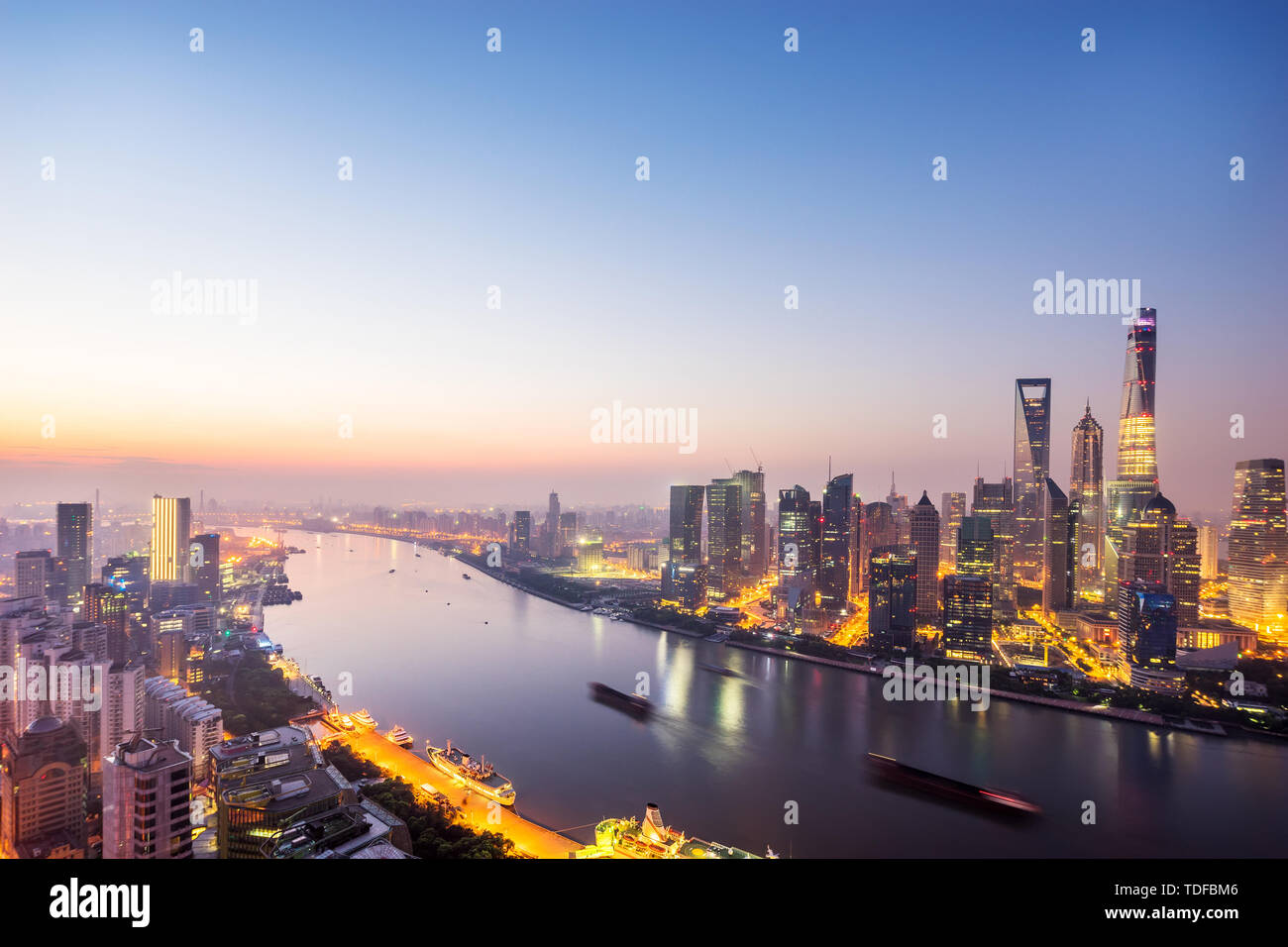 skyscrapers of the city in China around a river at dusk Stock Photo - Alamy