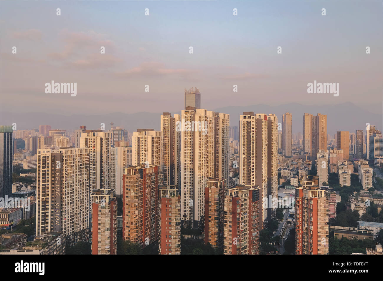 The sunset city of high-rise building Stock Photo - Alamy