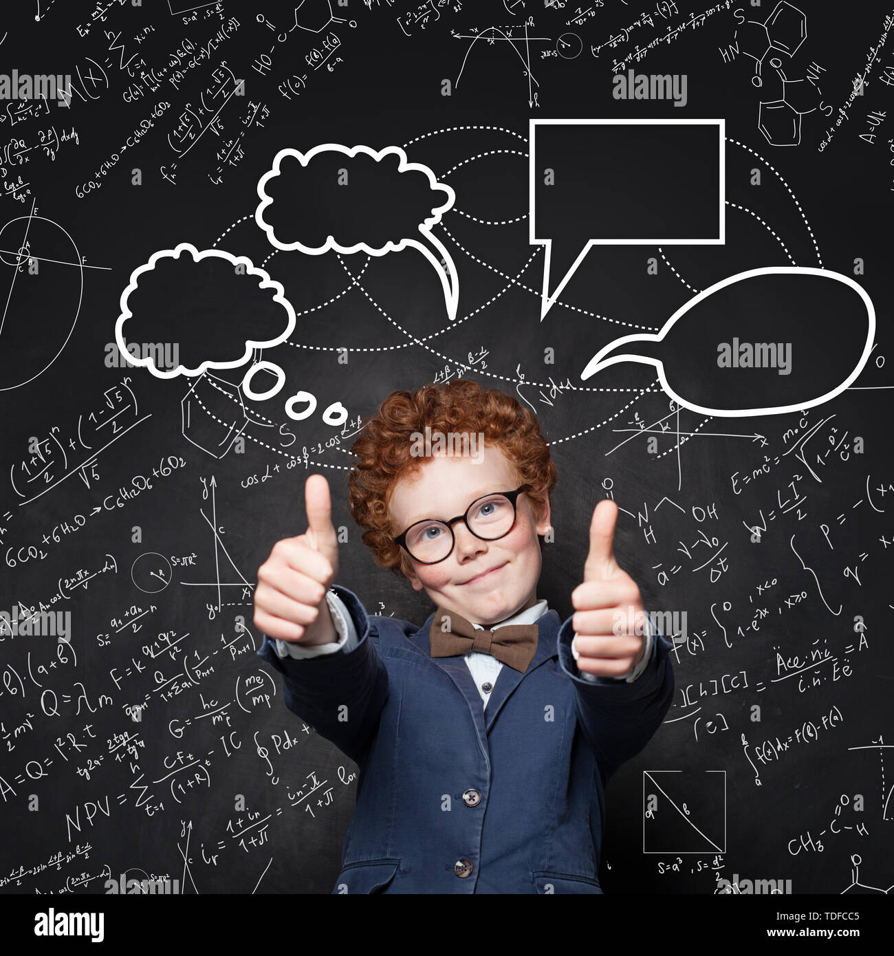 Child boy with ginger hair showing thumb up on blackboard background ...