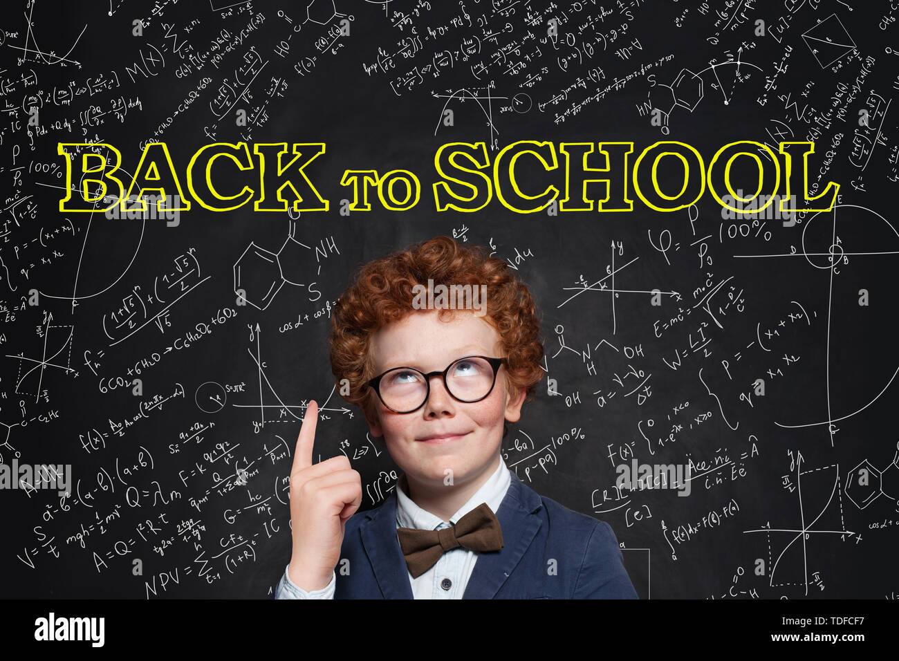 Back to school concept. Happy smart child smart student in classroom on ...