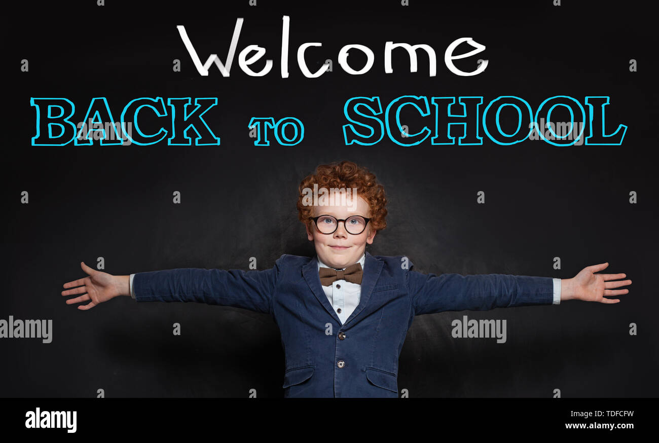 Happy kid student with Back to school text on chalkboard Stock Photo ...