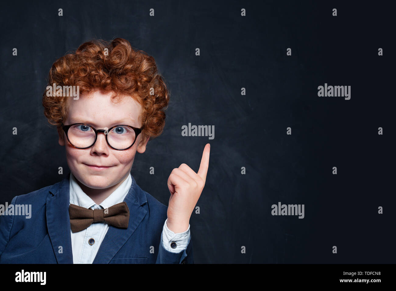 Child student pointing up on chalkboard background Stock Photo - Alamy