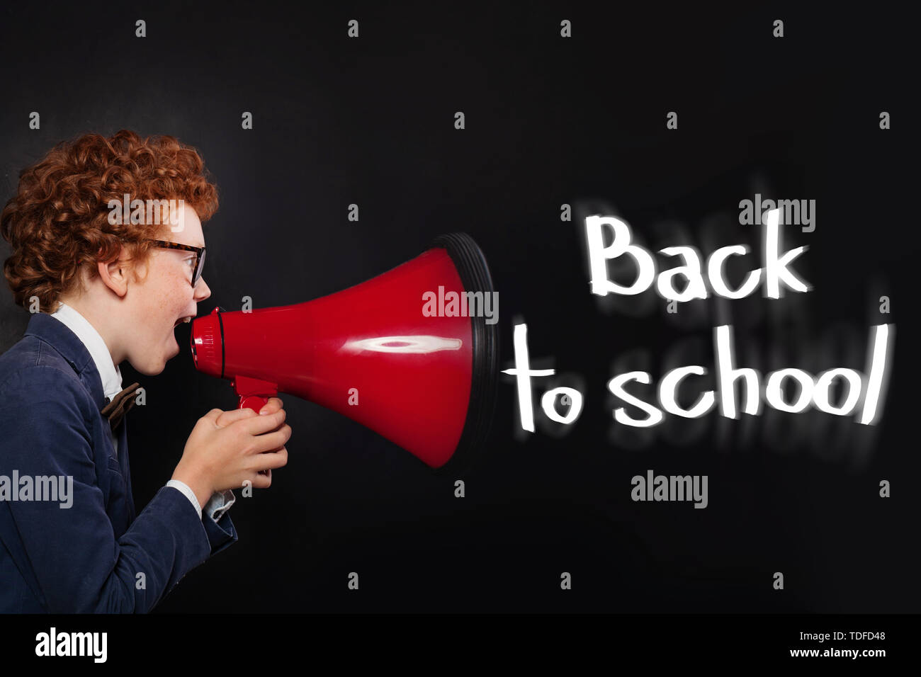 Happy child with loudspeaker shouting Back to school Stock Photo - Alamy