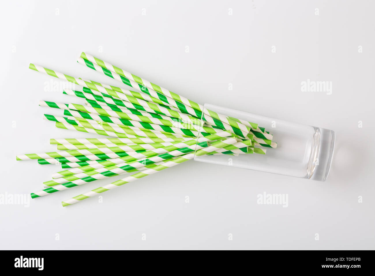 Green and blue striped paper straws on white background Stock Photo - Alamy