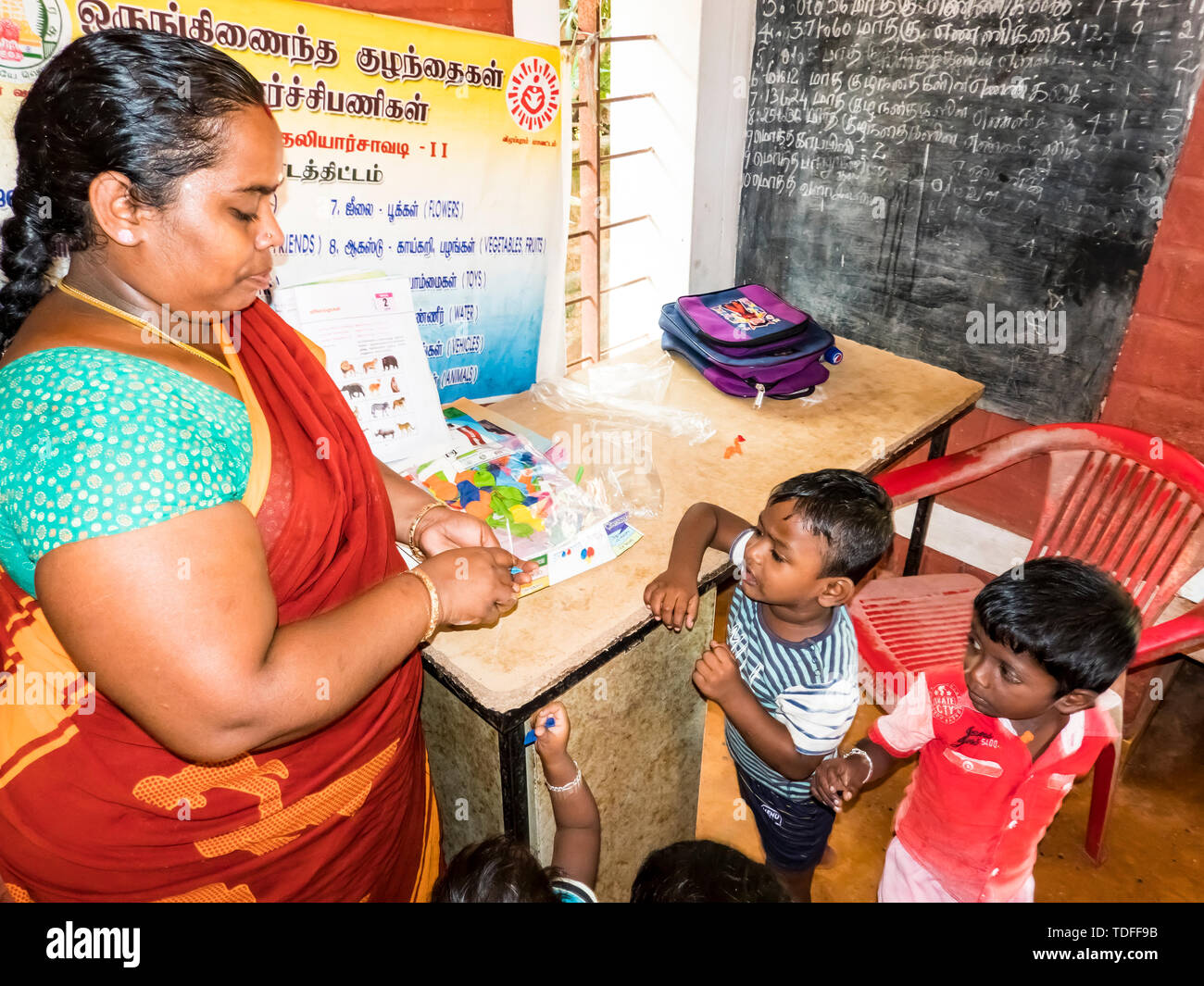 PUDUCHERY, INDIA - DECEMBER Circa, 2018. Poor preschool teacher and her ...