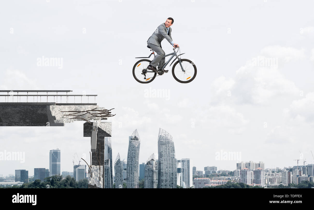 Businessman commuting to work by bike. Happy man wearing business suit ...