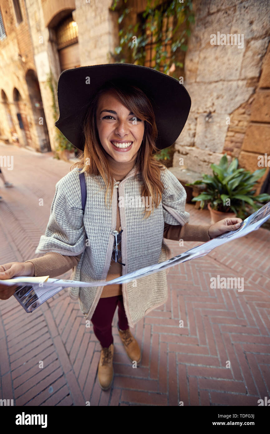 tourist’s girl reading map - Happy young girl on travel vacation in ...