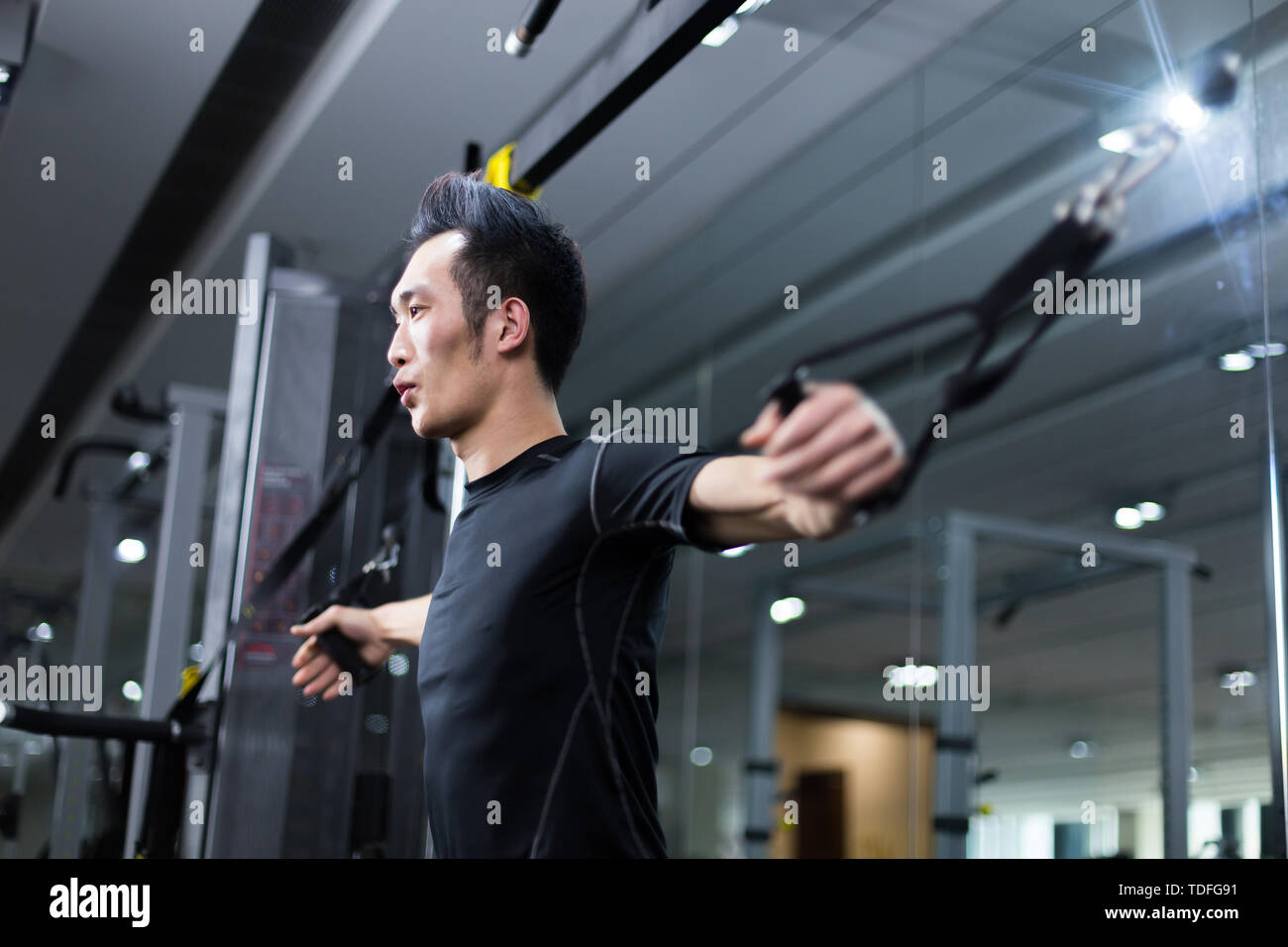 young asian man working out in modern gym Stock Photo - Alamy