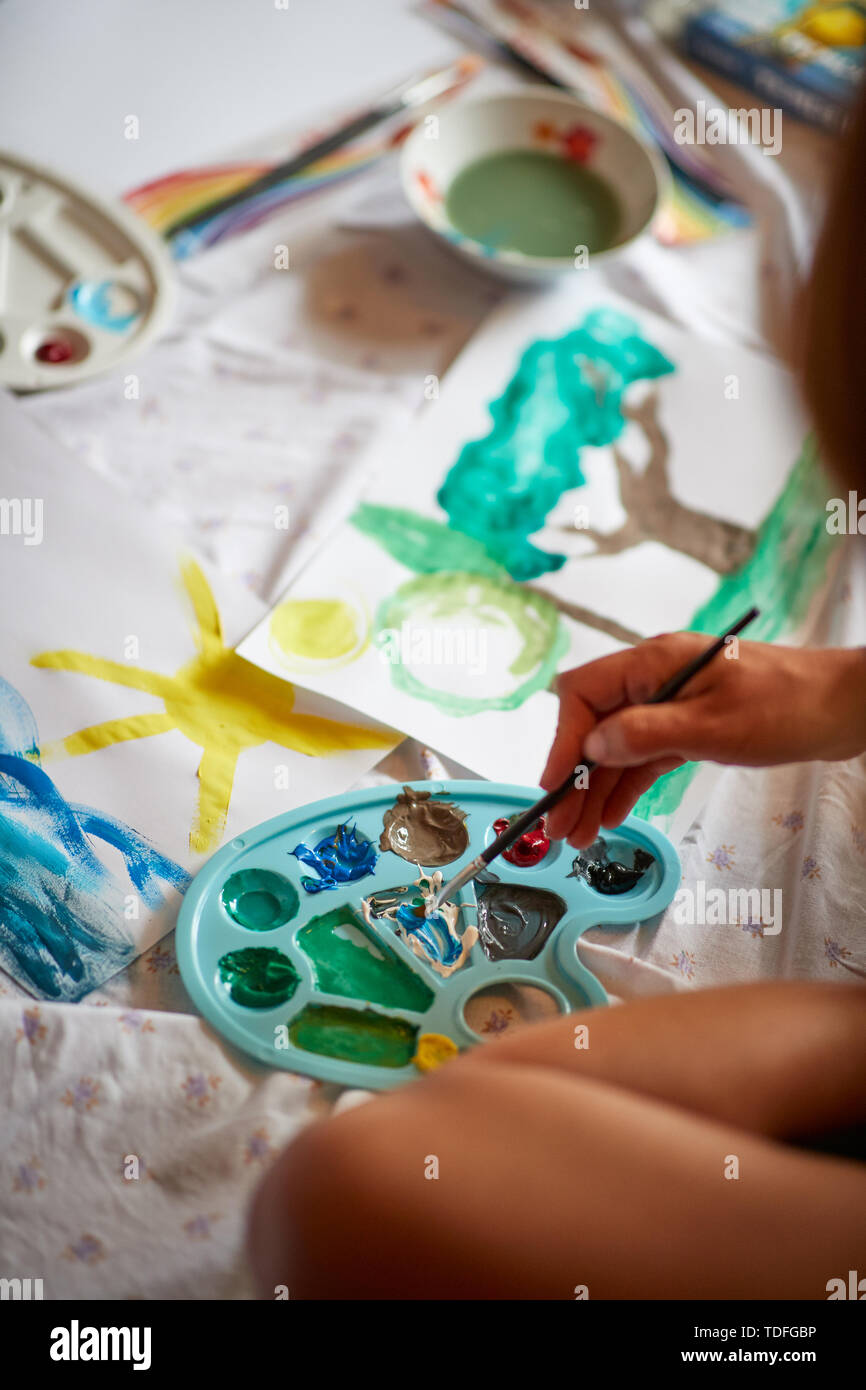Painting with tempera on pallete with brush Stock Photo - Alamy