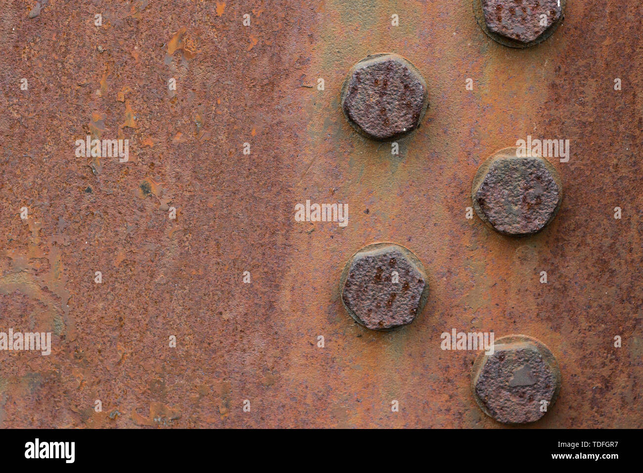 Rusty metal plate texture with bolts. Copy space Stock Photo - Alamy
