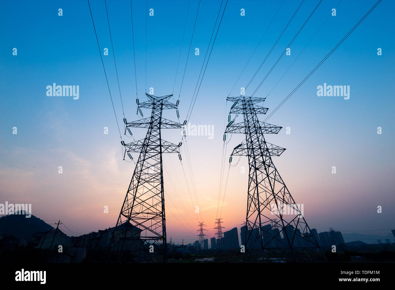 Pylons in blue sky at sunrise Stock Photo - Alamy