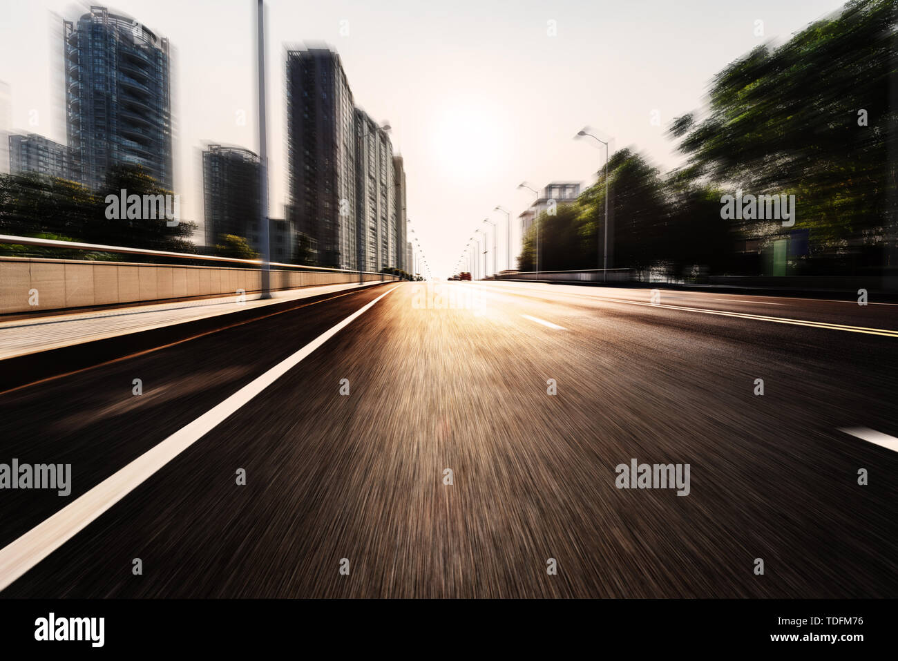 sunlight skyline and road by modern buildings Stock Photo - Alamy