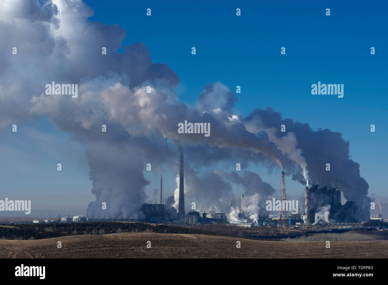 Chemical plant flue gas emissions, thick smoke billowing, cover the sun ...