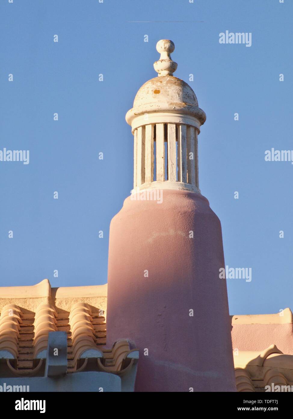 Pink Algarve chimney very close in front of blue sky Stock Photo - Alamy