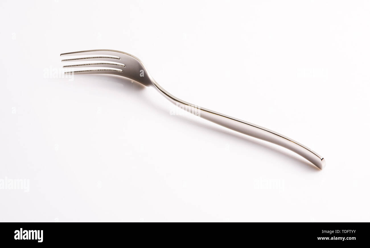 A silver fork on a white background Stock Photo - Alamy