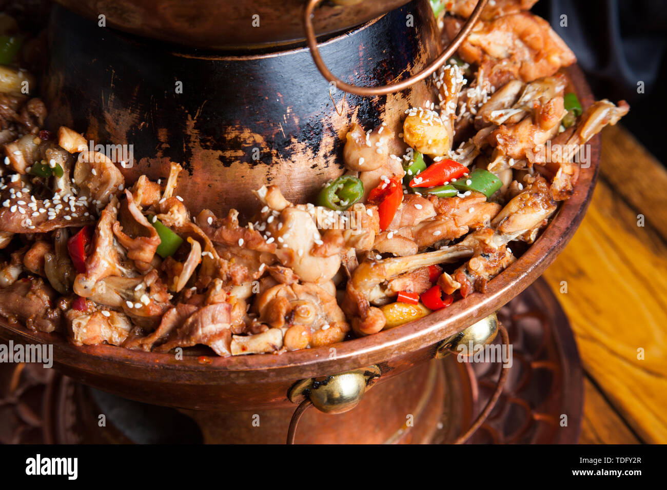 Charcoal fire frog pot field chicken meal Stock Photo - Alamy