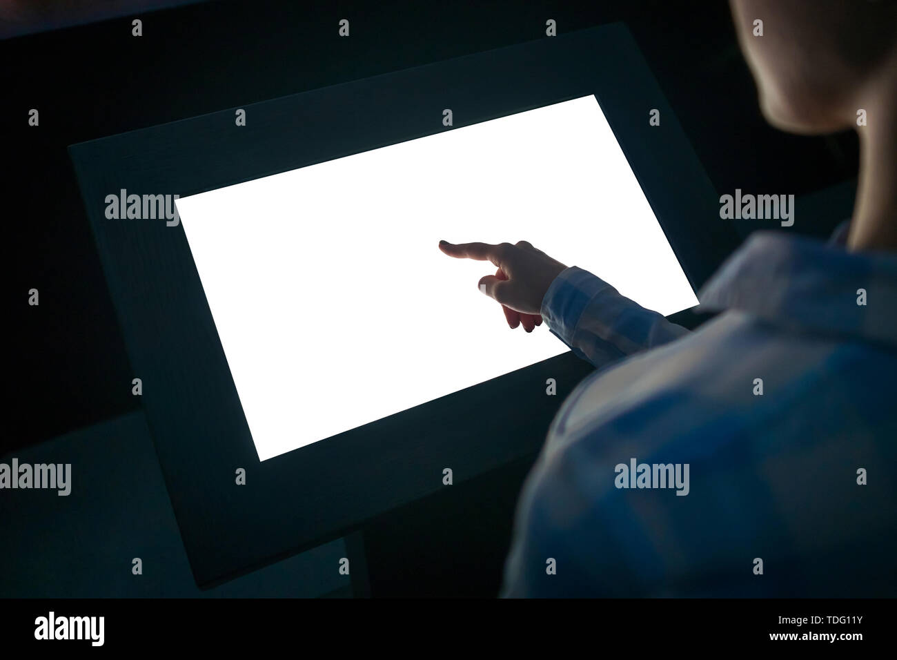 Woman hand using white blank interactive touchscreen display of ...