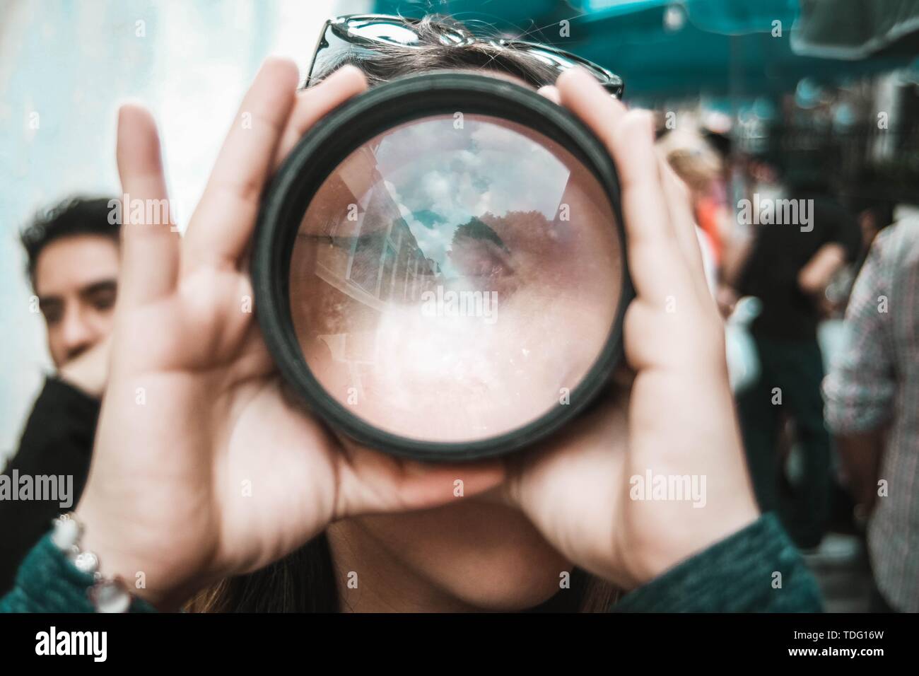 A person holding a magnifying glass in front of their face Stock Photo ...