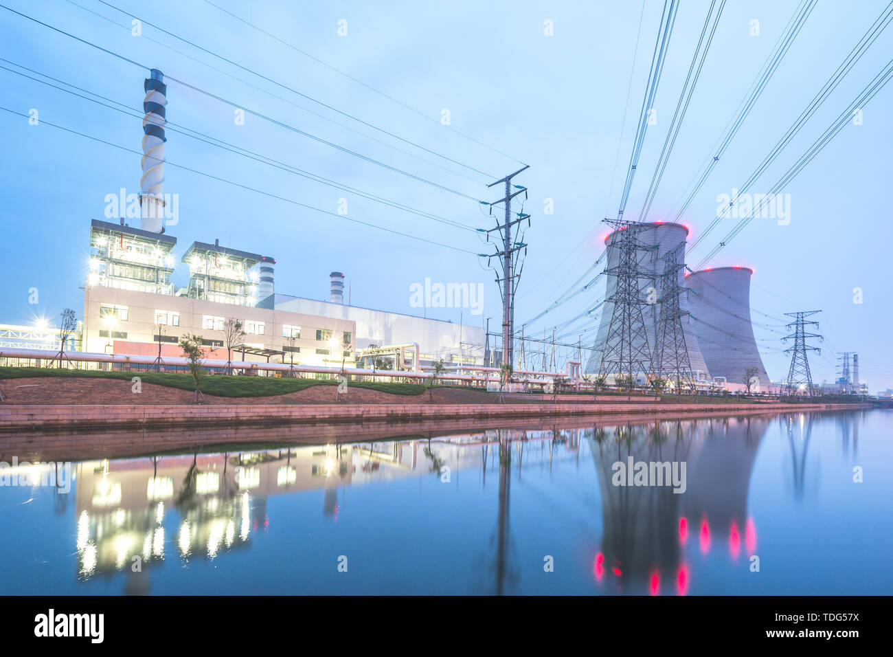 modern factory near river in blue sky at dawn Stock Photo - Alamy
