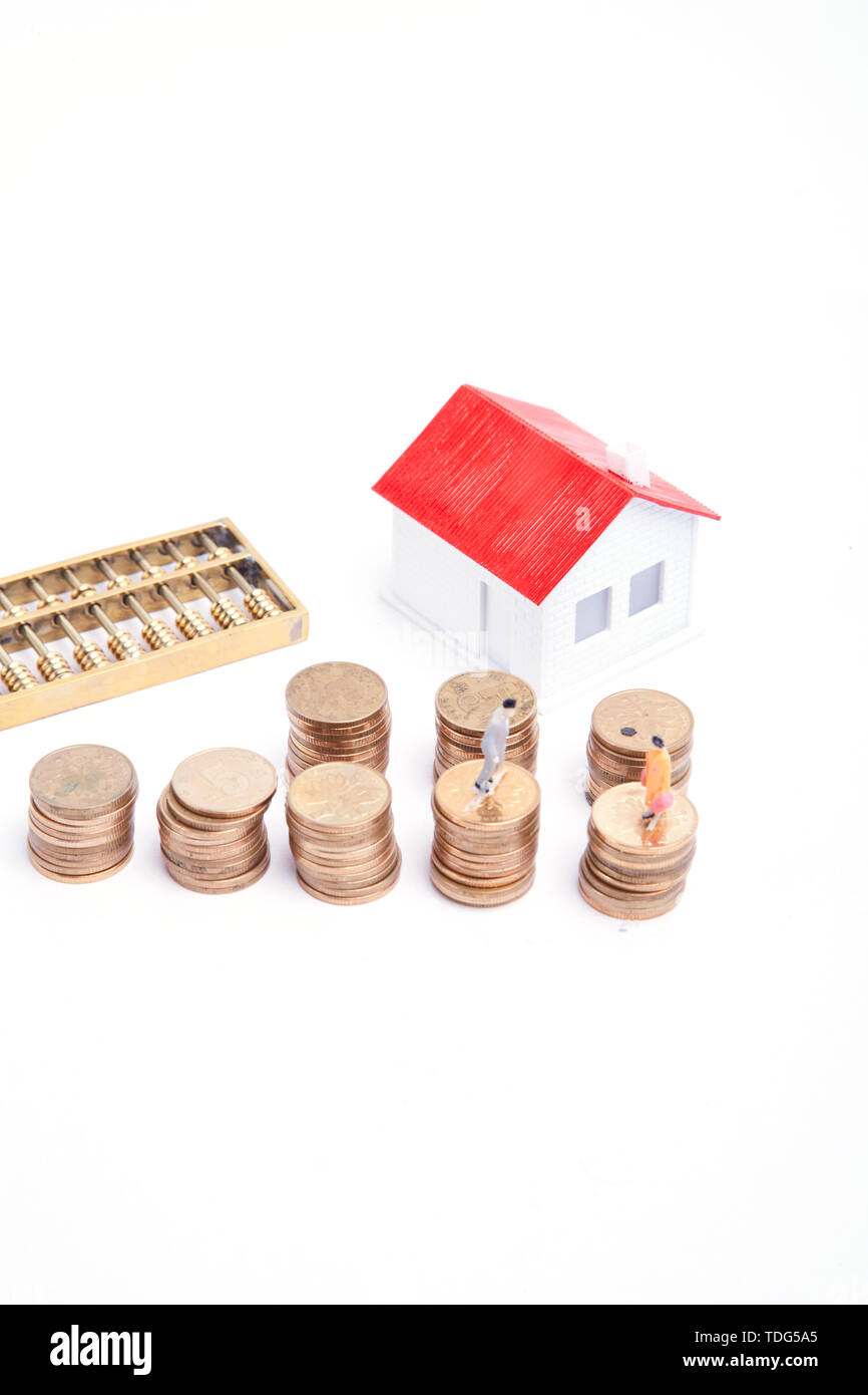 Coin house model and couple on white background Stock Photo - Alamy