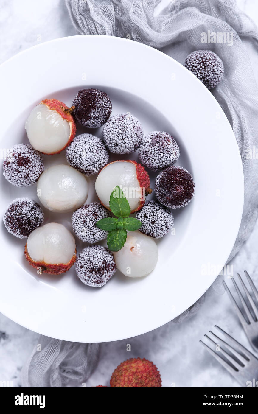 Frozen plum and fresh lychee Stock Photo - Alamy