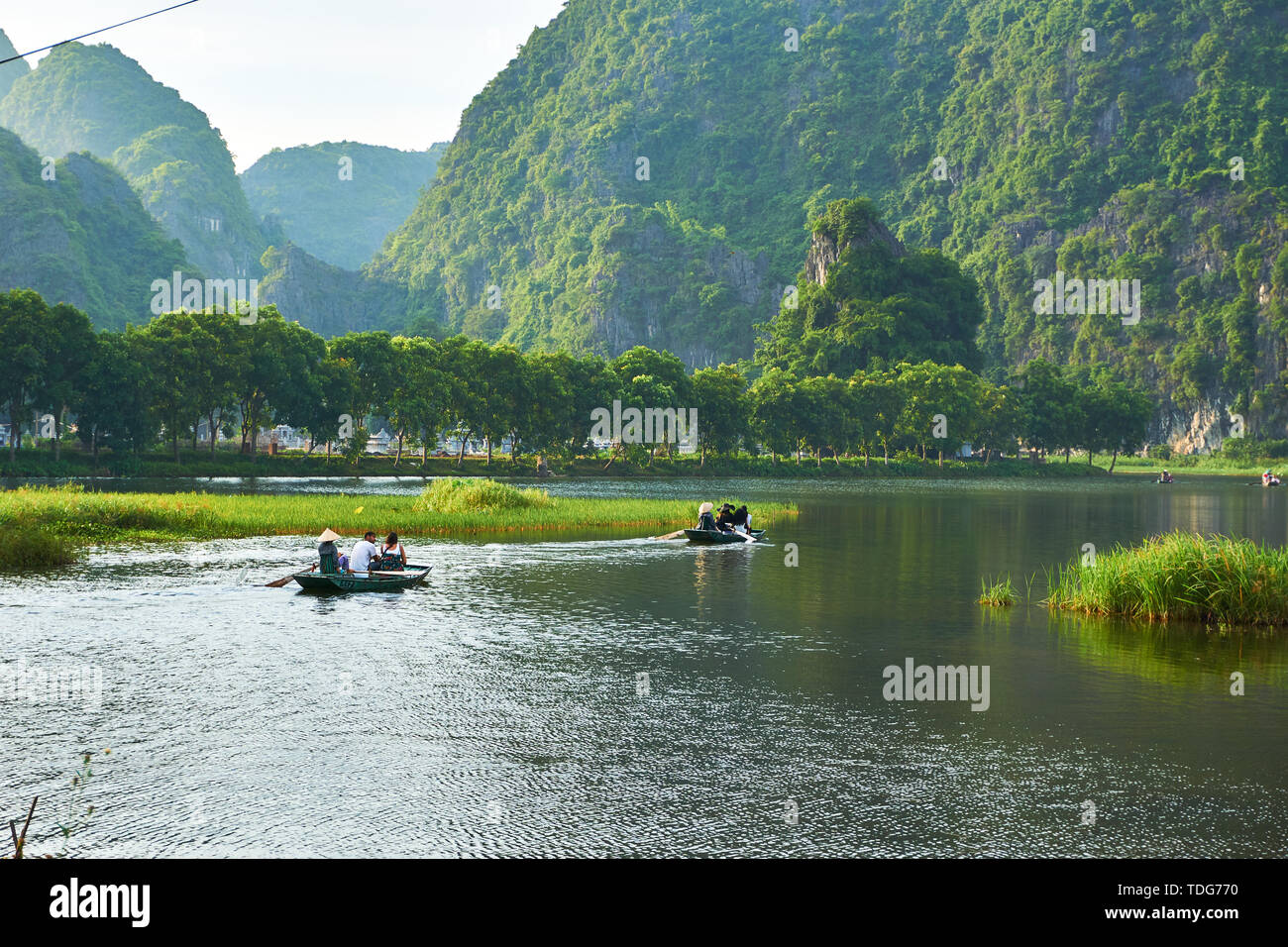 Tam Coc, Vietnam - June 8, 2019: Tourist taking boat tour through tam ...