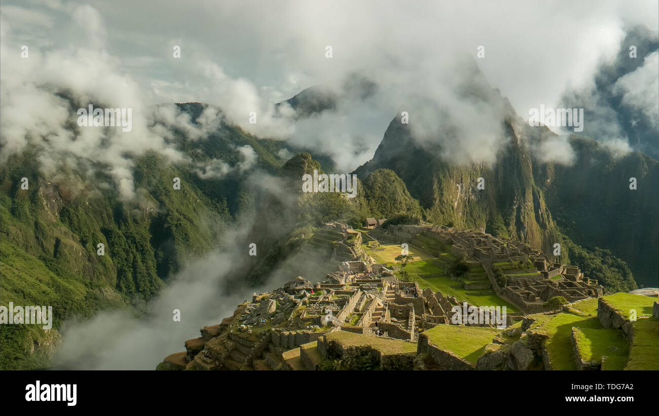 view of peru's famous lost inca city of machu picchu on a misty morning ...