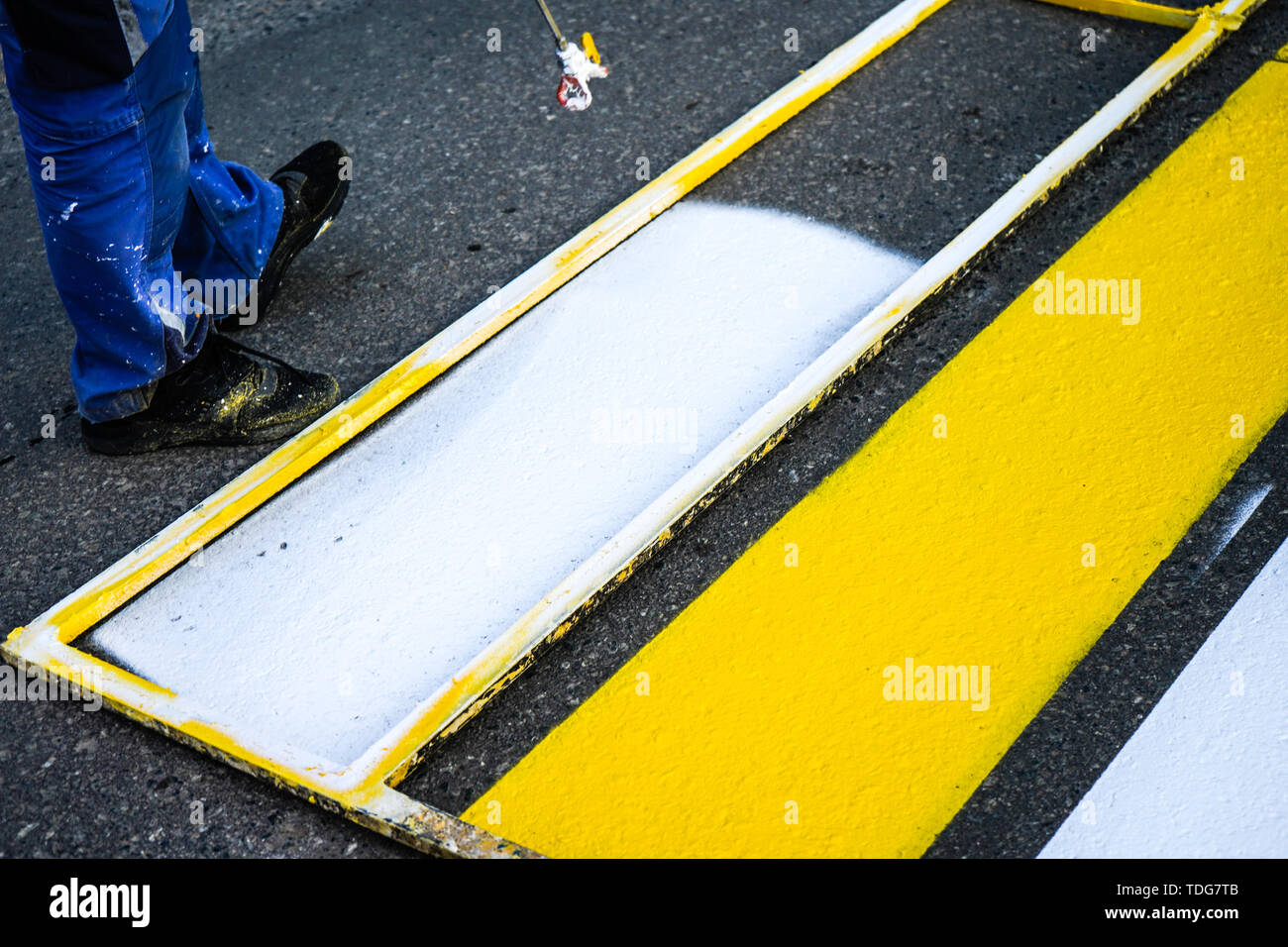 Road marking. Painting road lines. Workers draw white and yellow ...