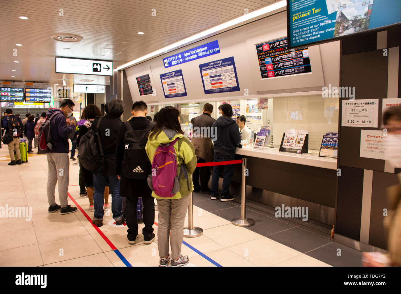 Japanese people and foreign travelers passenger wait and stand in queue ...