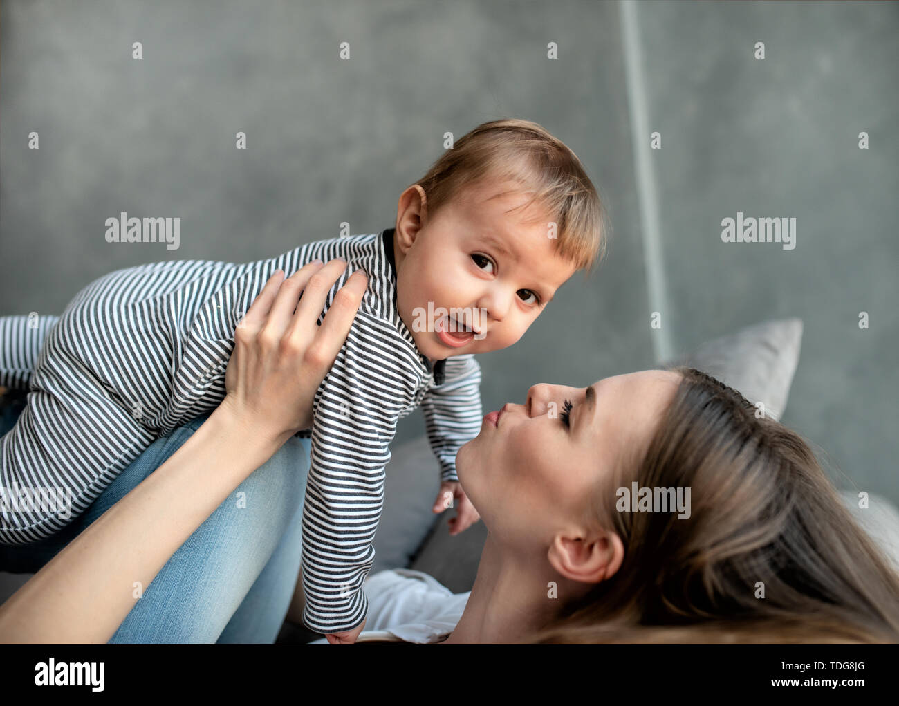 Little child smiling and happy with mom Stock Photo - Alamy