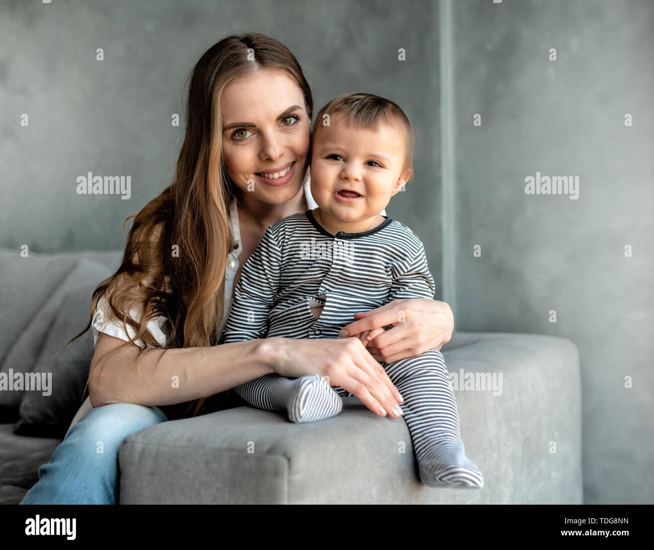 Little child smiling and happy with mom Stock Photo - Alamy
