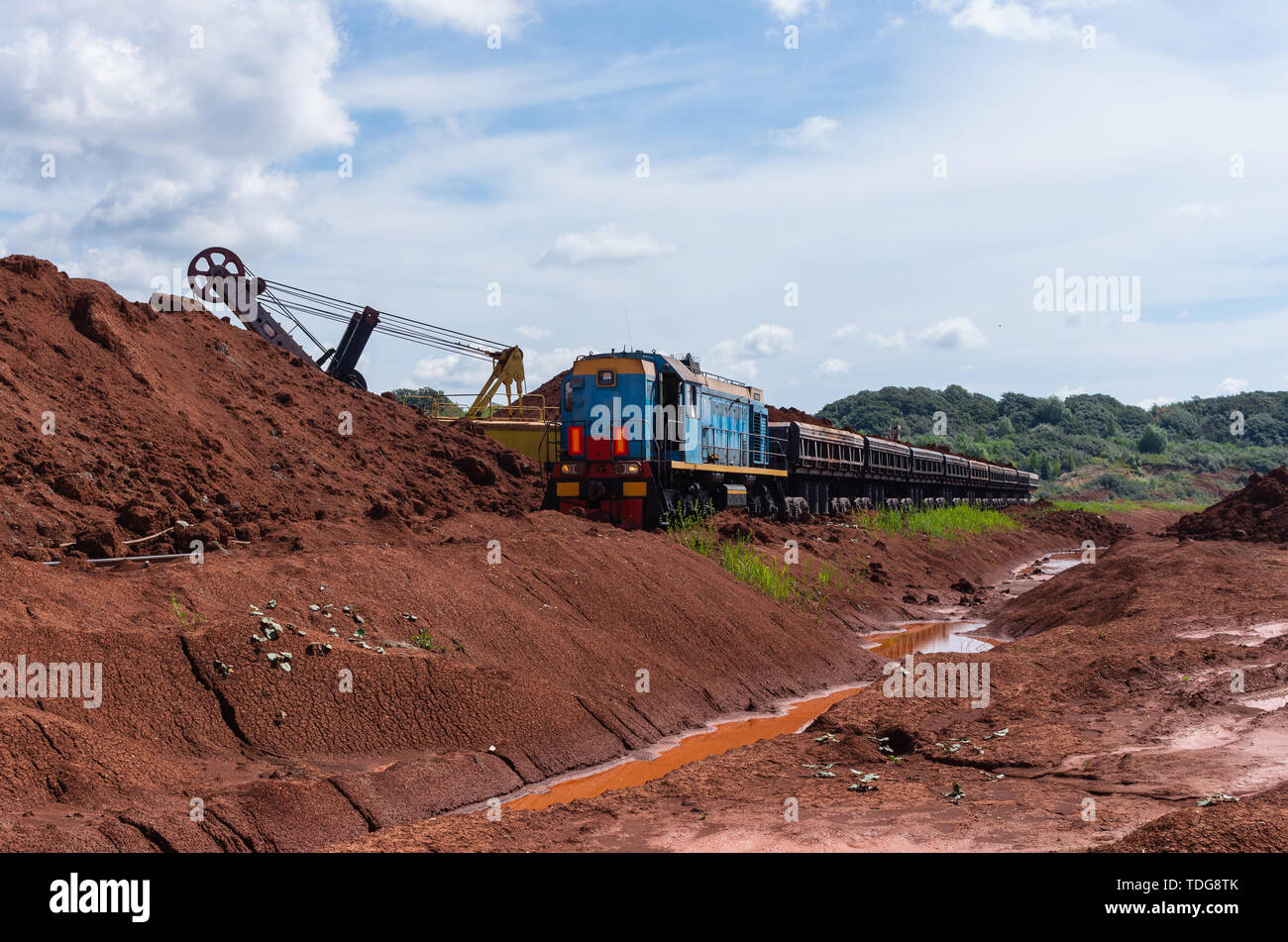 Excavator loading clay to the train on the opencast mining site Stock ...