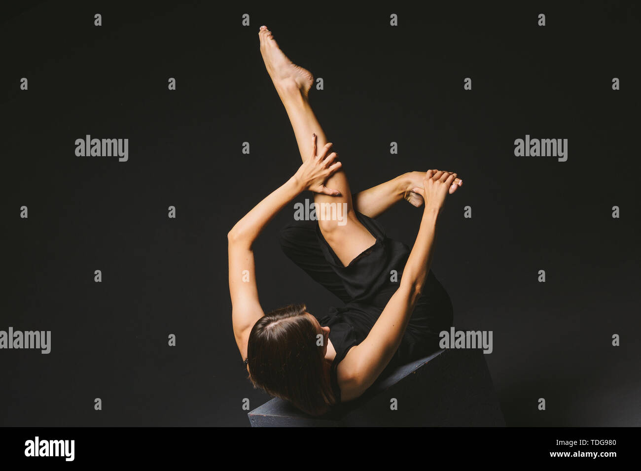 Social theme. young Caucasian woman in strange pose in dress posing on ...