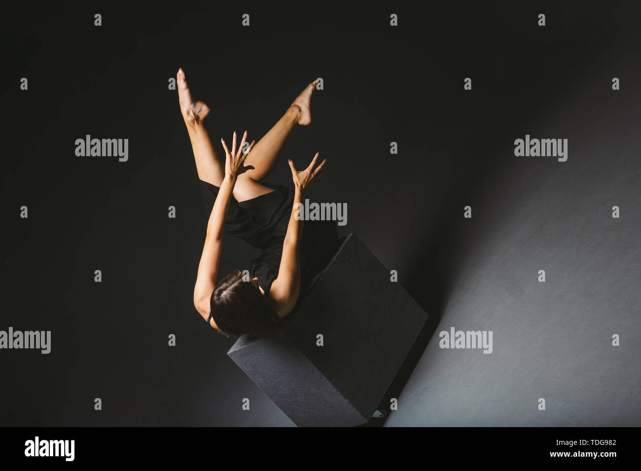 Social theme. young Caucasian woman in strange pose in dress posing on ...