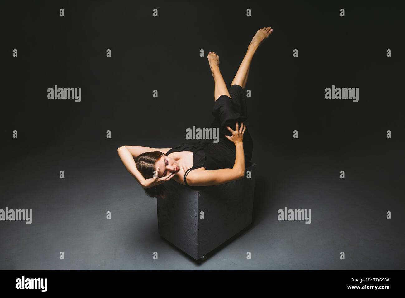 Social theme. young Caucasian woman in strange pose in dress posing on ...