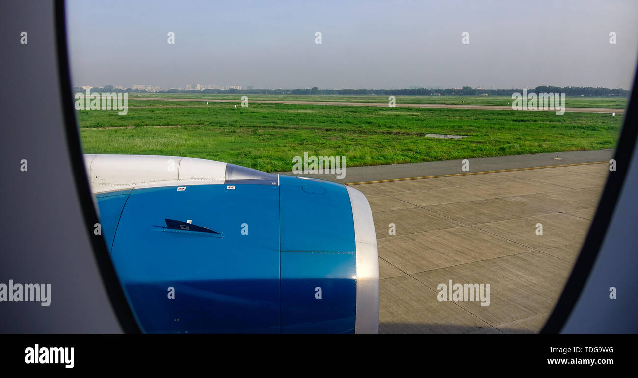 Blue engine of passenger airplane with airfield background Stock Photo ...