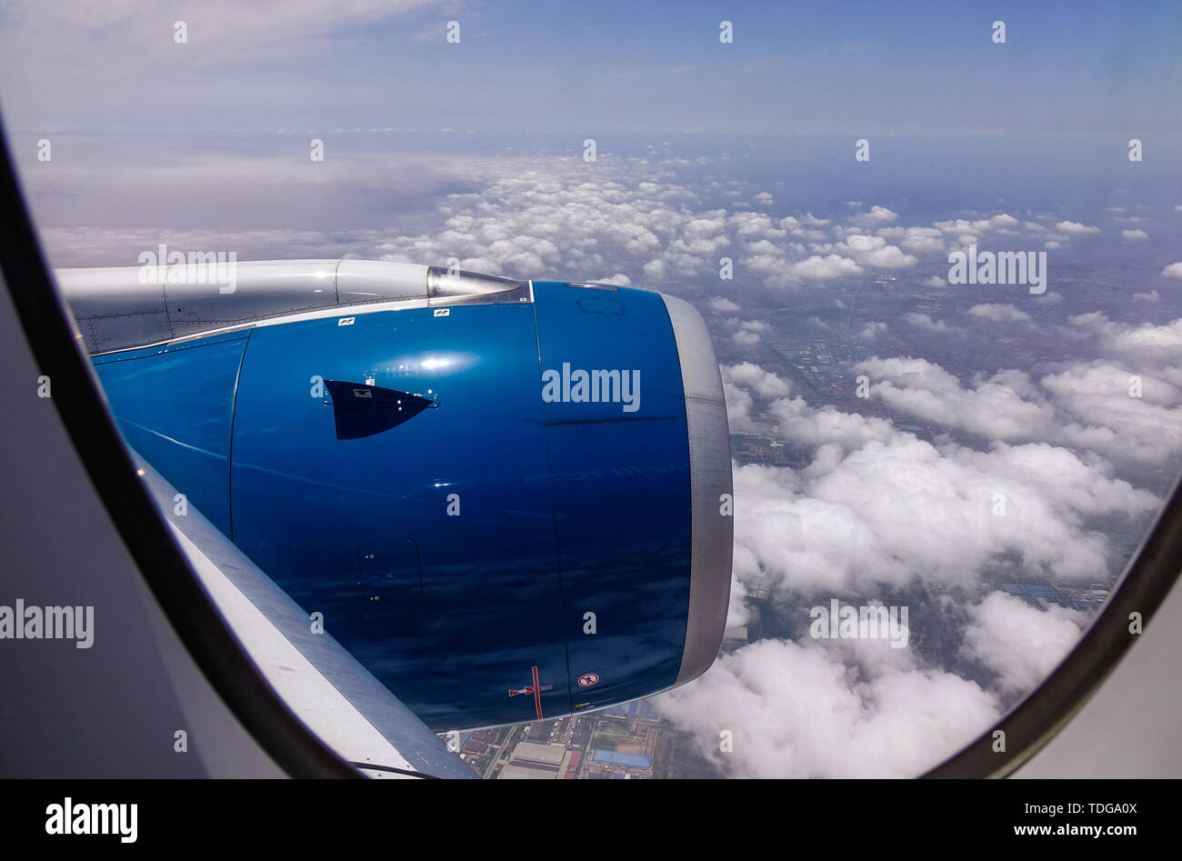 Blue engine of passenger airplane with cloudscape background in sunny ...