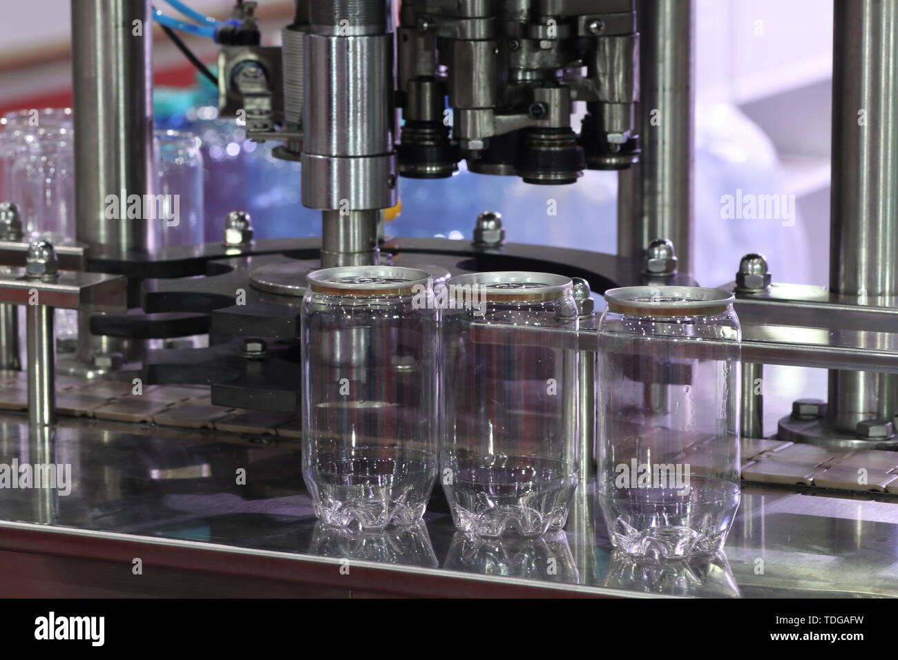 Aluminum lid packing machine for plastic can ; factory Stock Photo - Alamy