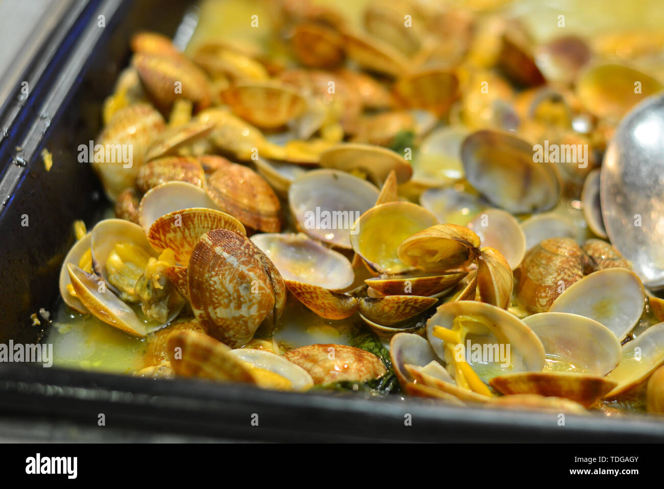 Clam with hot sauce at buffet restaurant. Food concept Stock Photo - Alamy