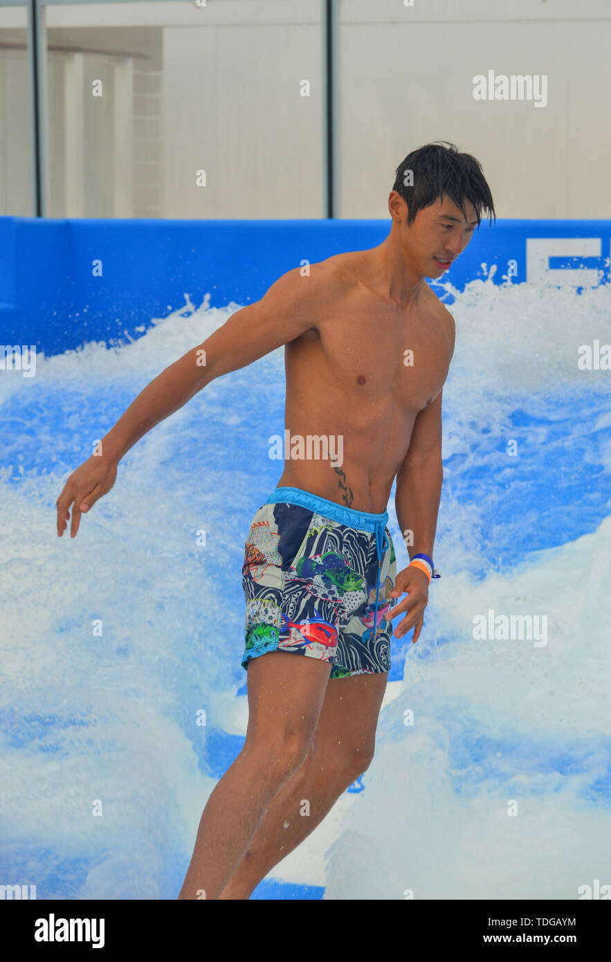 Shanghai, China - Jun 4, 2019. A Chinese man surfing on the Flow Rider ...