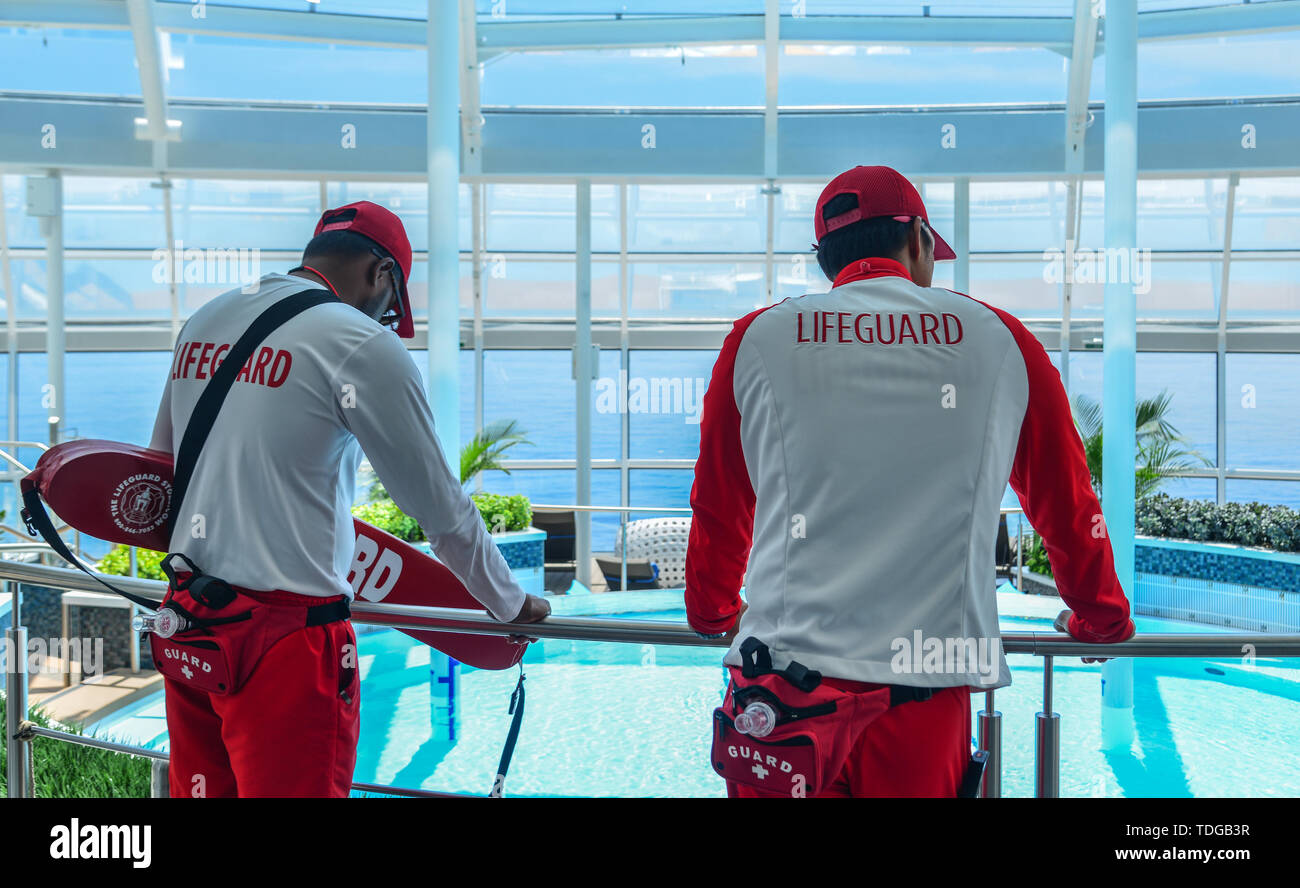 Shanghai, China - May 5, 2019. Lifeguard guys working at swimming pool ...